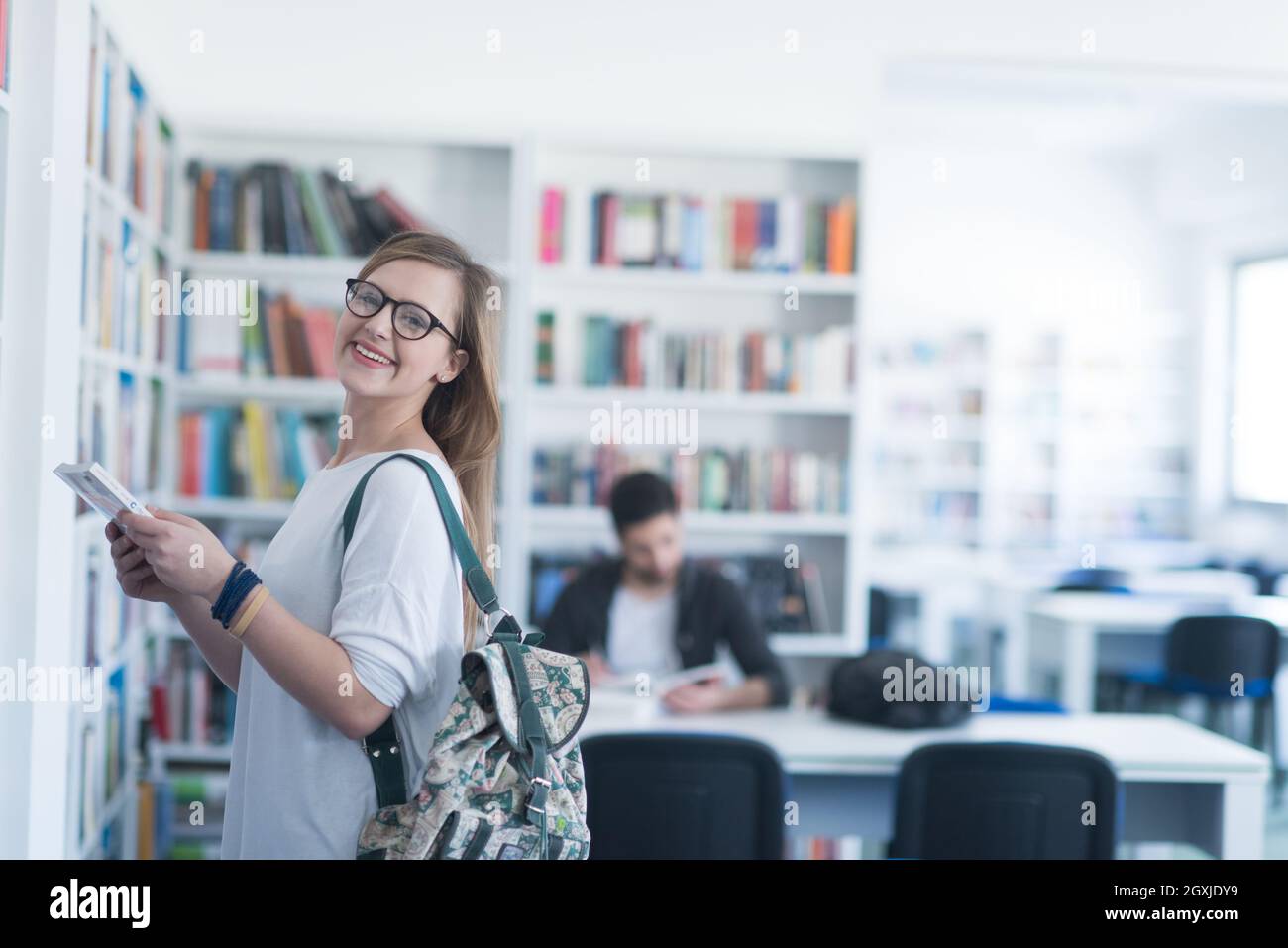 smart looking famale student girl in collage school library selecting ... smart looking famale student girl in collage school library selecting ...