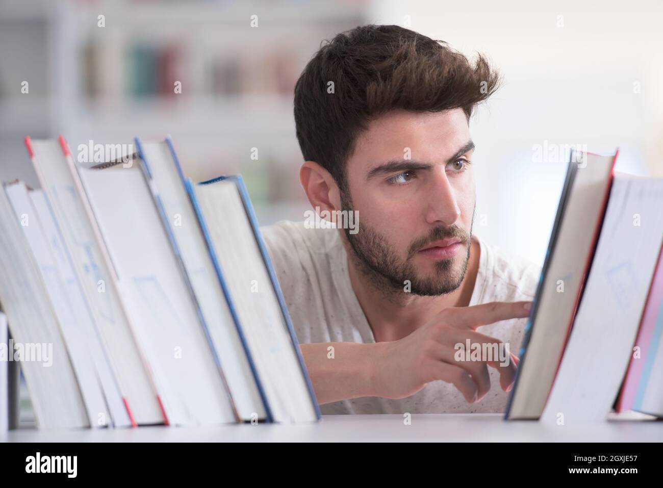 Student reading book in school library. Study lessons for exam. Hard ...