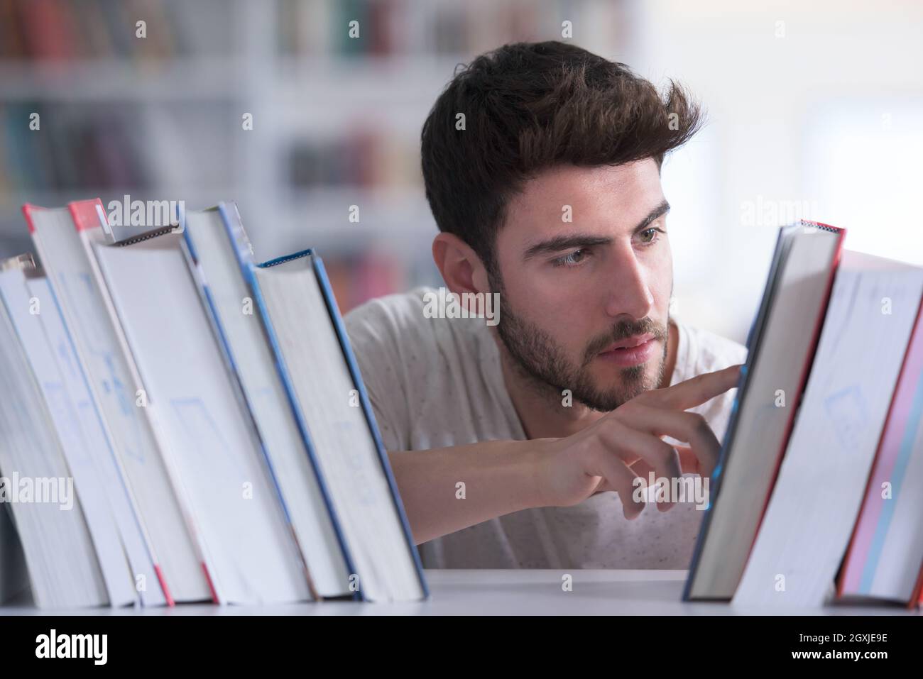 Student reading book in school library. Study lessons for exam. Hard ...
