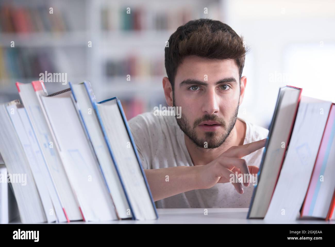 Student reading book in school library. Study lessons for exam. Hard ...