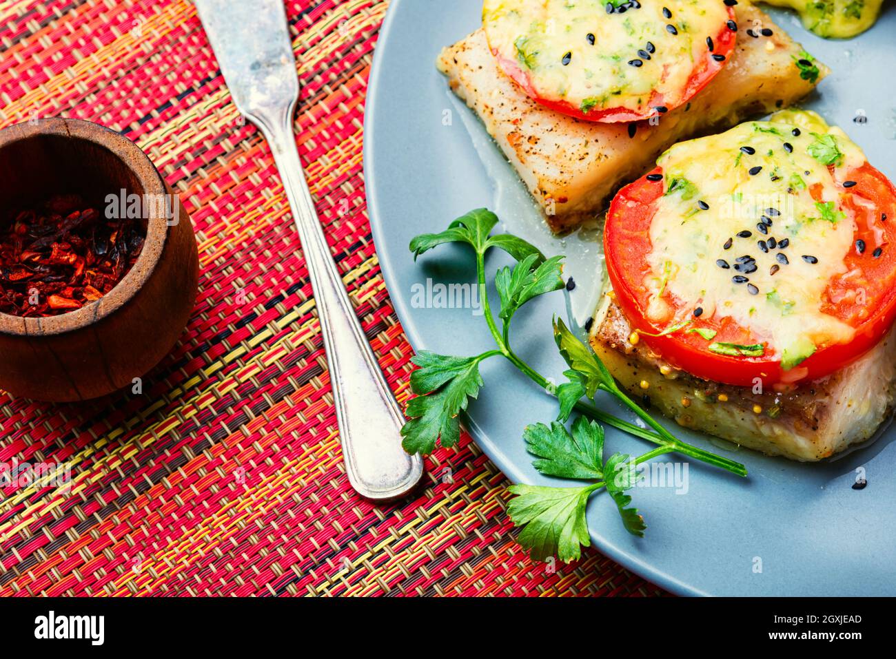 Slice of fish baked with cheese,tomato and herbs.Roasted pangasius ...