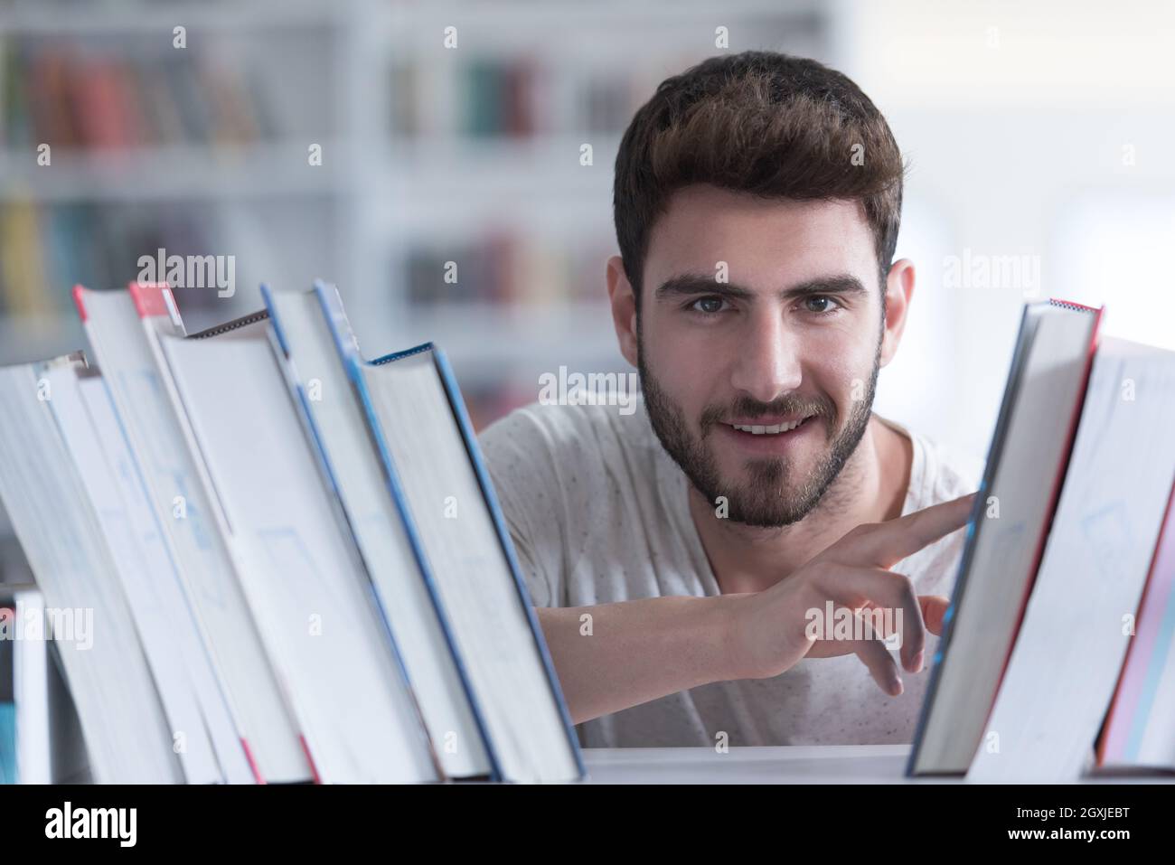 Student reading book in school library. Study lessons for exam. Hard ...