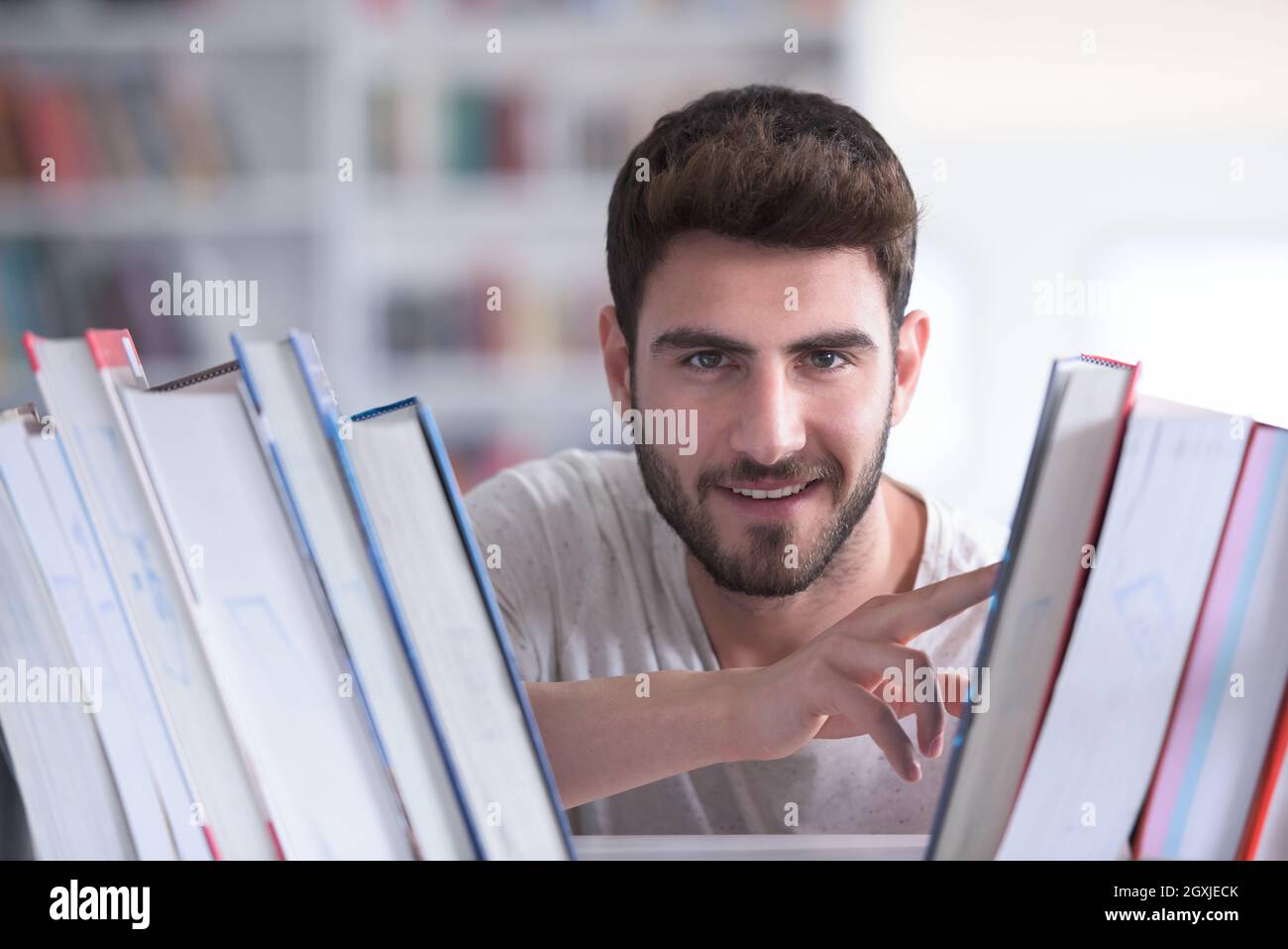 Student reading book in school library. Study lessons for exam. Hard ...
