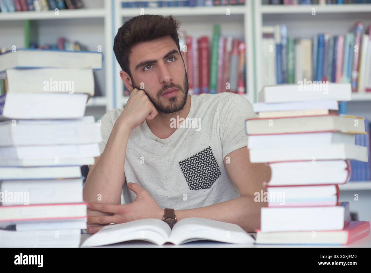 Student reading book in school library. Study lessons for exam. Hard ...