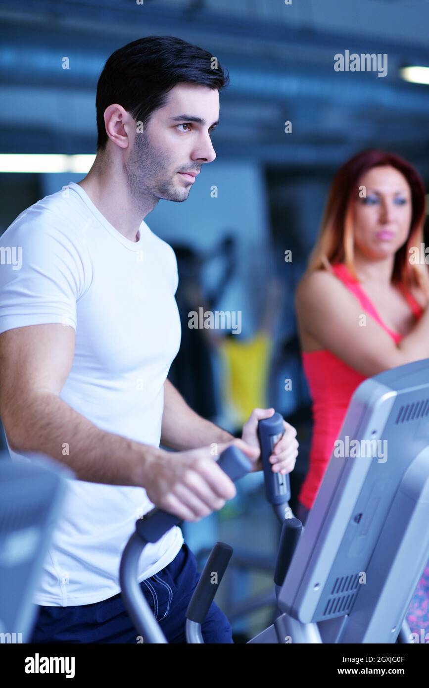 Handsome man running on the treadmill in modern gym Stock Photo - Alamy