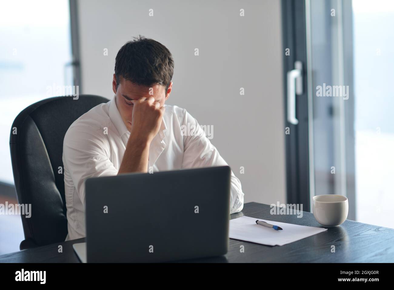 frustrated with problems young business man working on laptop computer ...