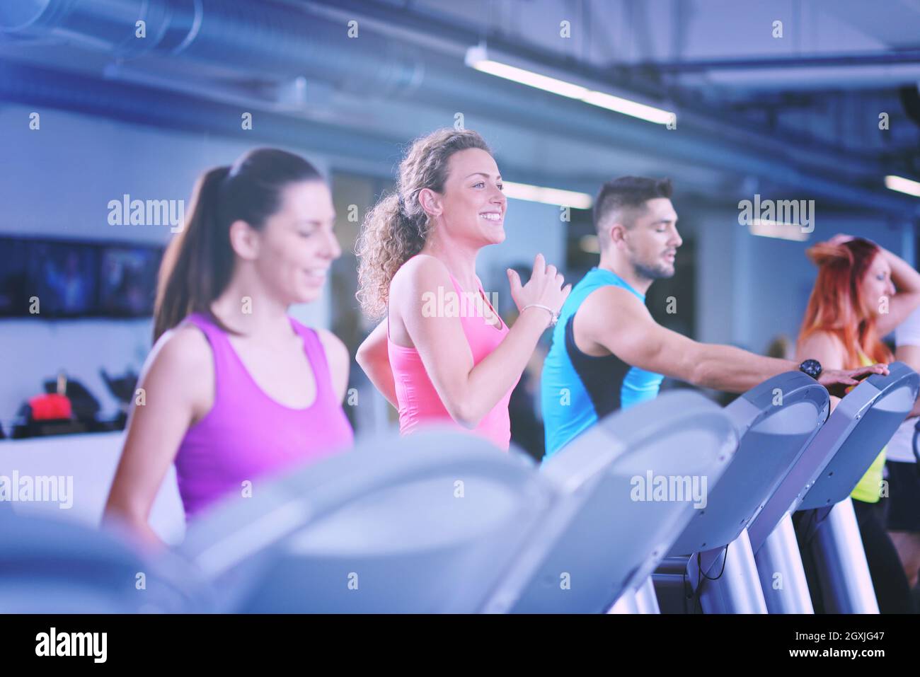 group of young people running on treadmills in modern sport gym Stock ...