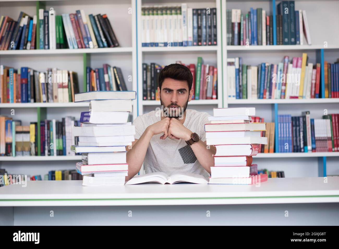 Student reading book in school library. Study lessons for exam. Hard ...