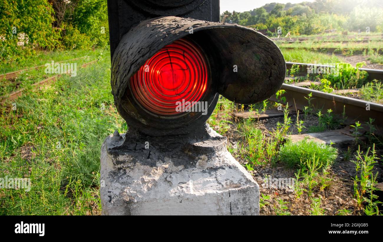 Old red semaphore with broken glass working on railroad at ...