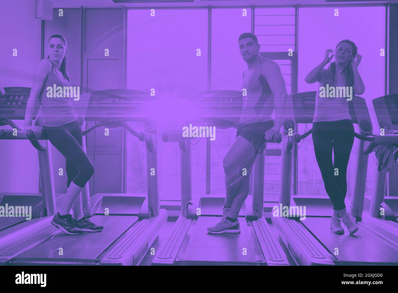 group of young people running on treadmills in modern sport gym duo ...