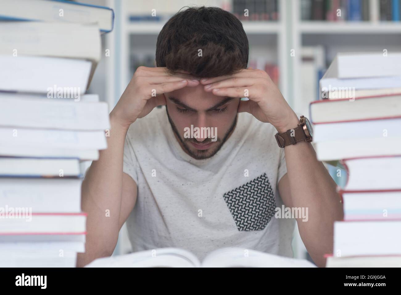 Student reading book in school library. Study lessons for exam. Hard ...