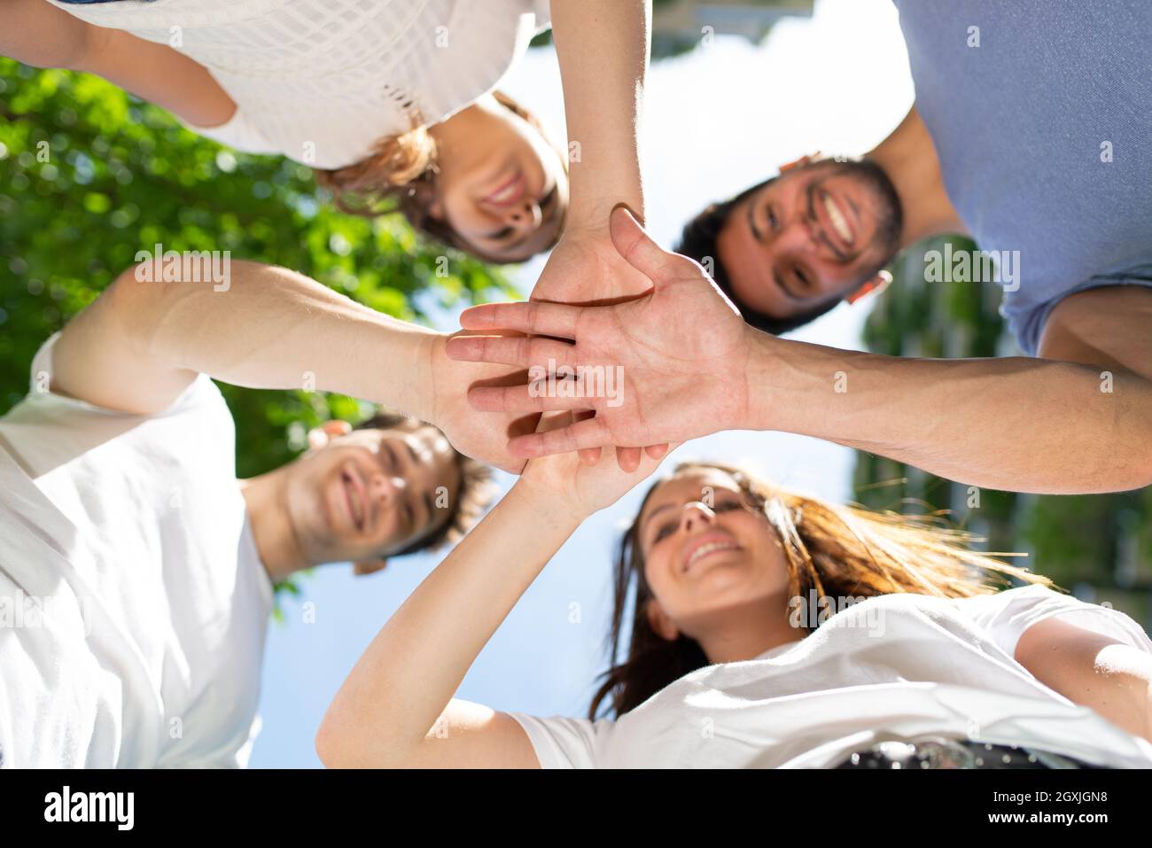 Group of friends putting their hands together, friendship concept Stock ...