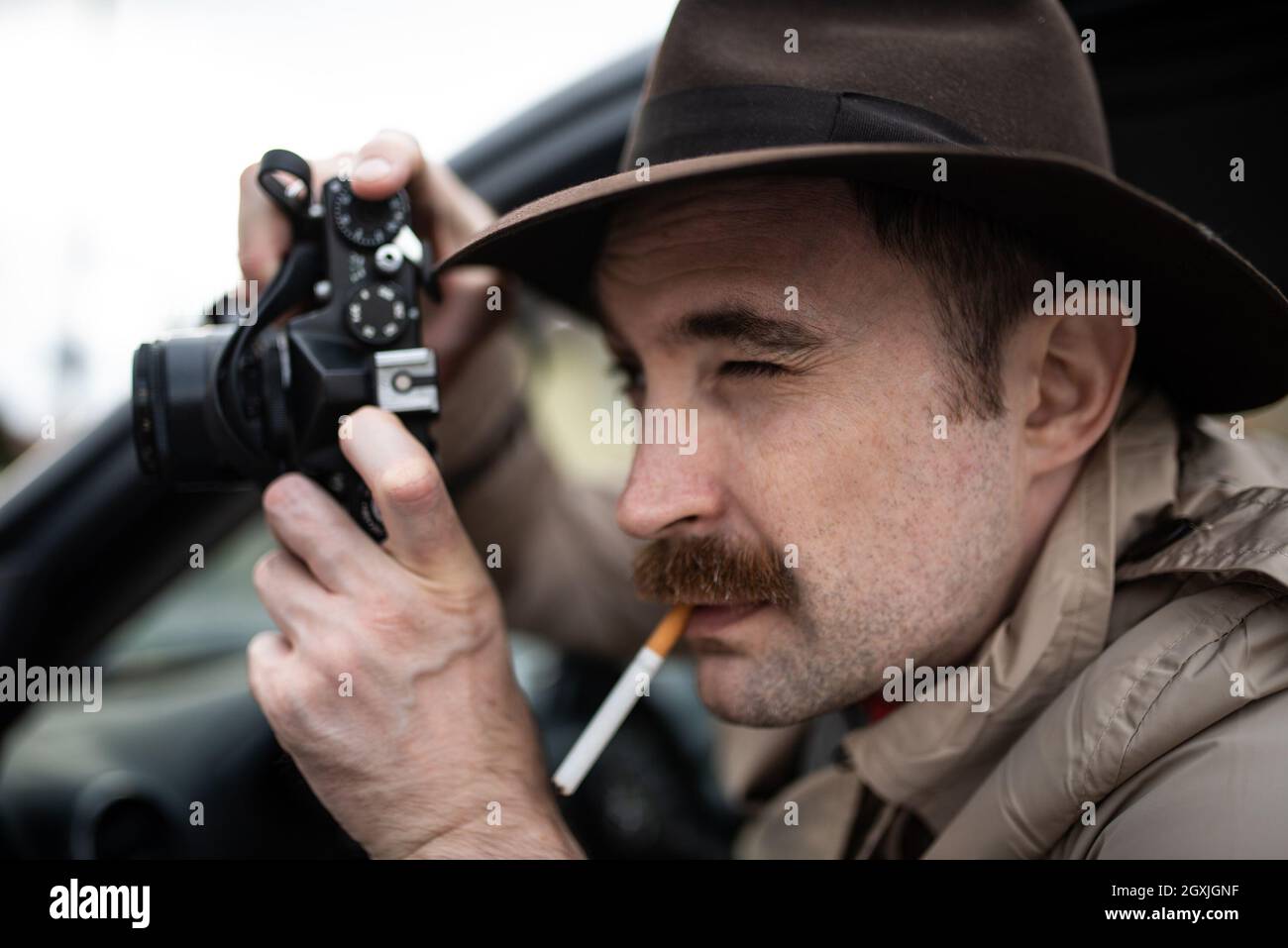Spy or paparazzo photographer, detective using camera in his car Stock ...