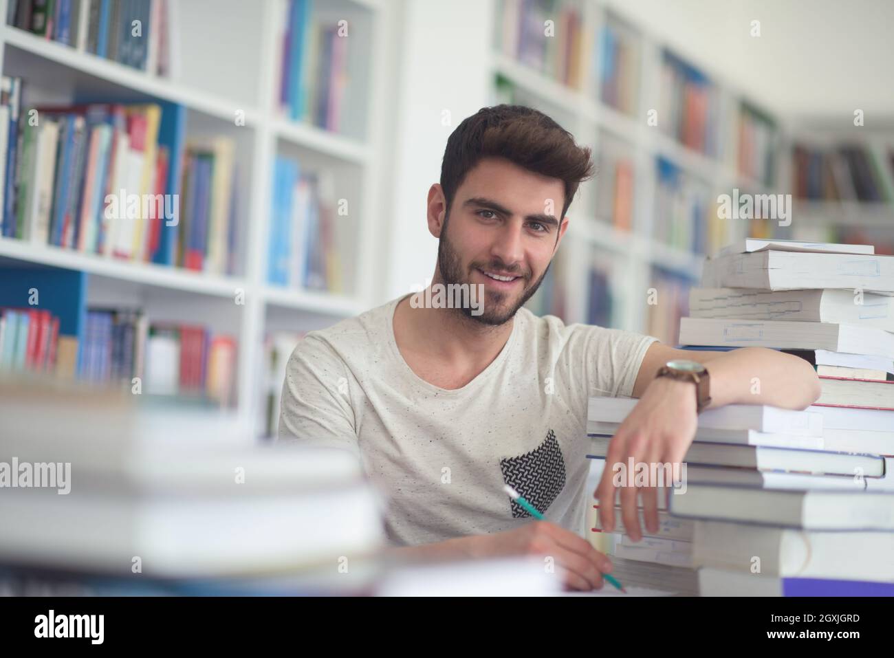 Student reading book in school library. Study lessons for exam. Hard ...