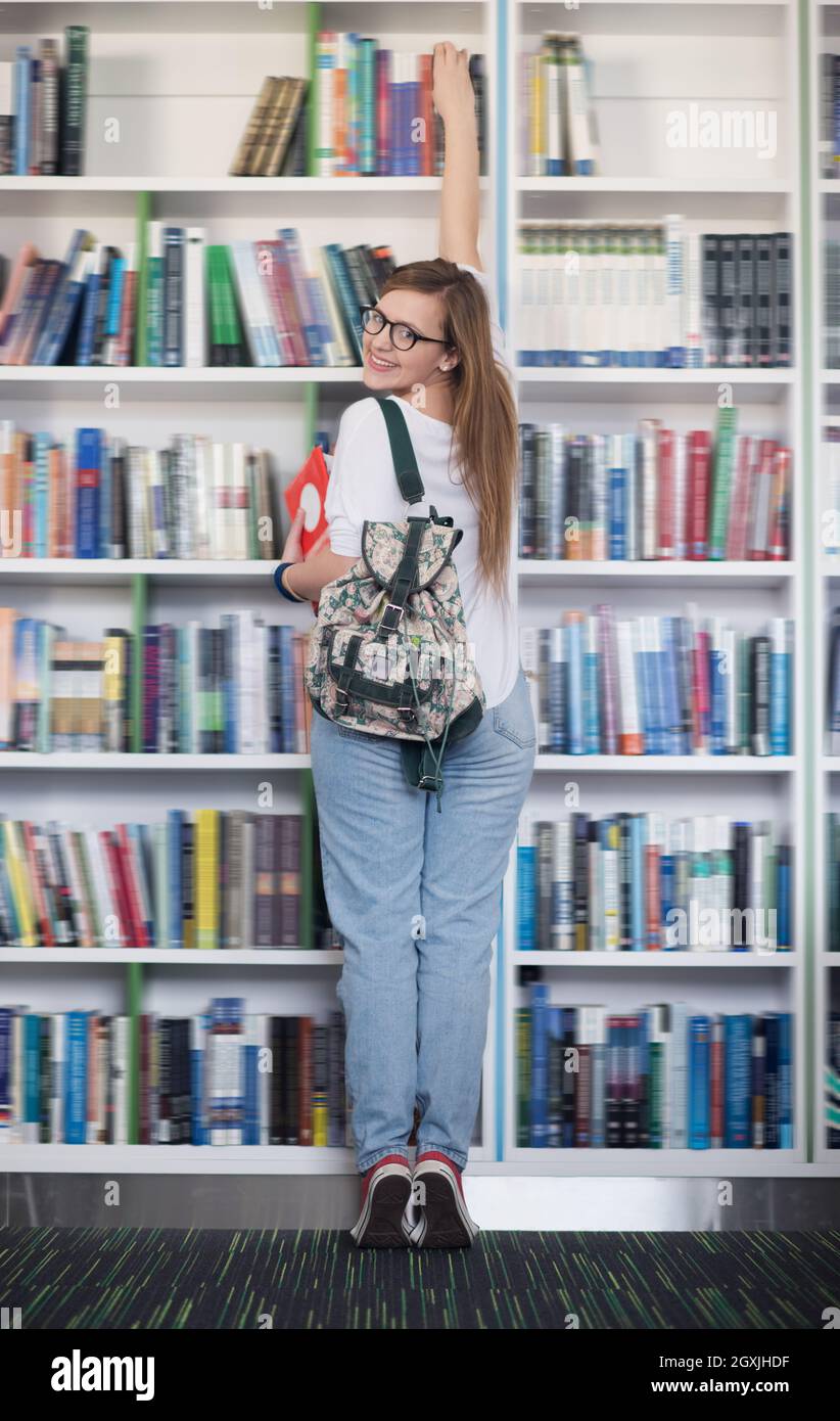 smart looking famale student girl in collage school library selecting ... smart looking famale student girl in collage school library selecting ...