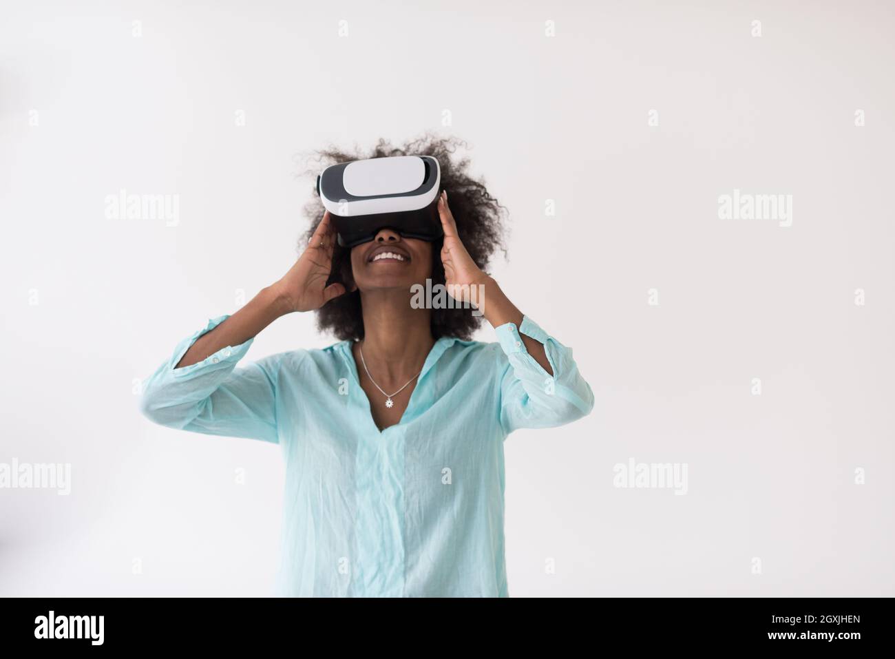 Happy african american girl getting experience using VR headset glasses ...
