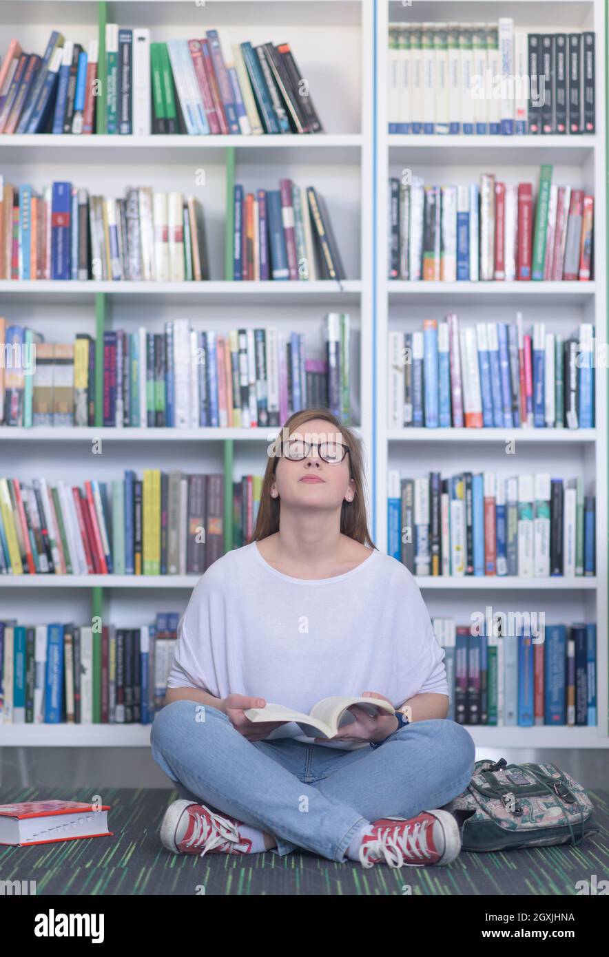 smart looking famale student girl in collage school library reading ...