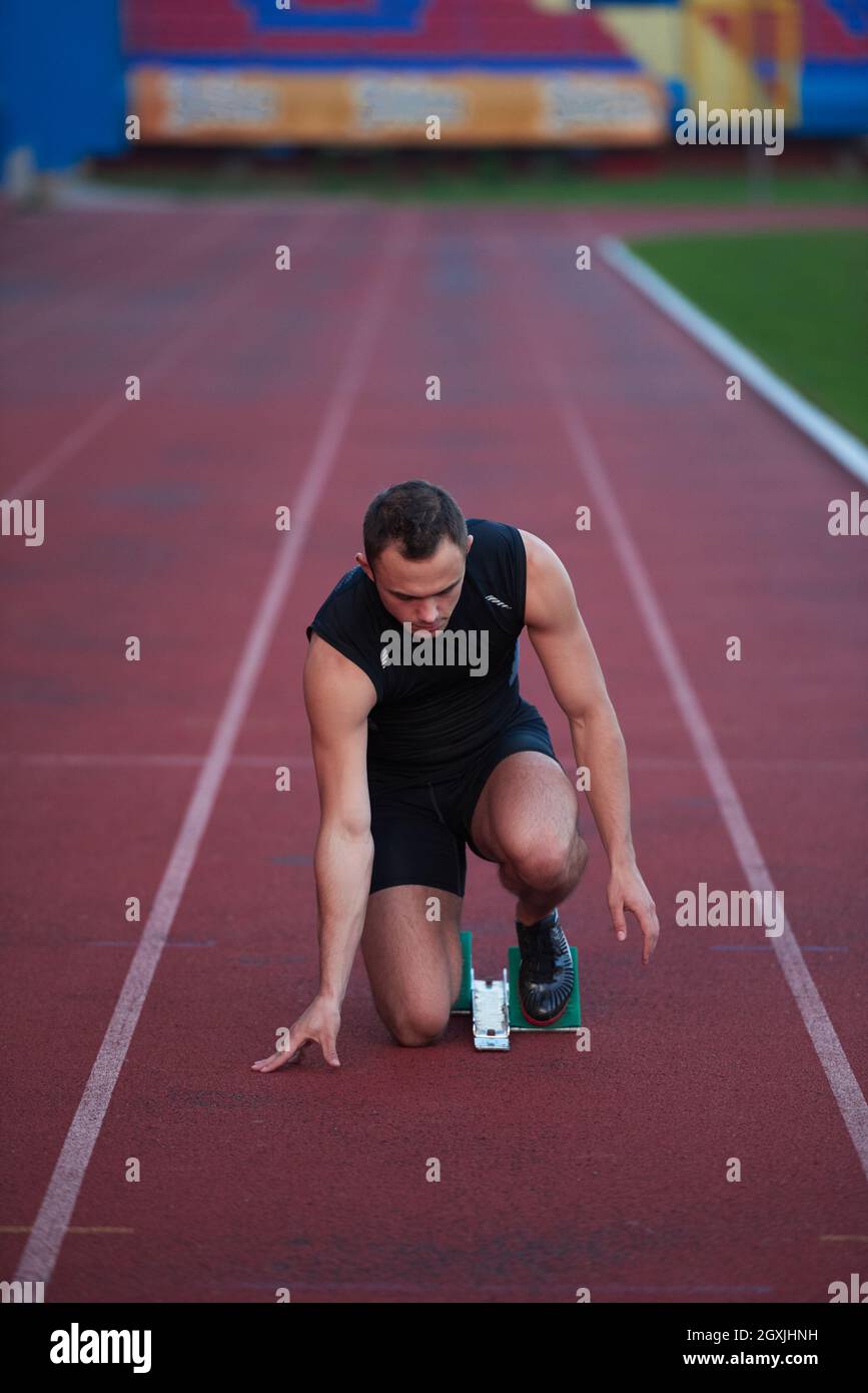 Sprinter leaving starting blocks on the running track. Explosive start ...