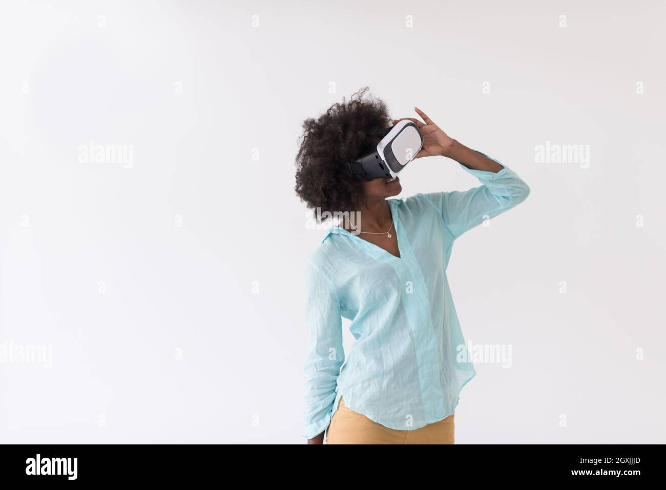 Happy african american girl getting experience using VR headset glasses ...