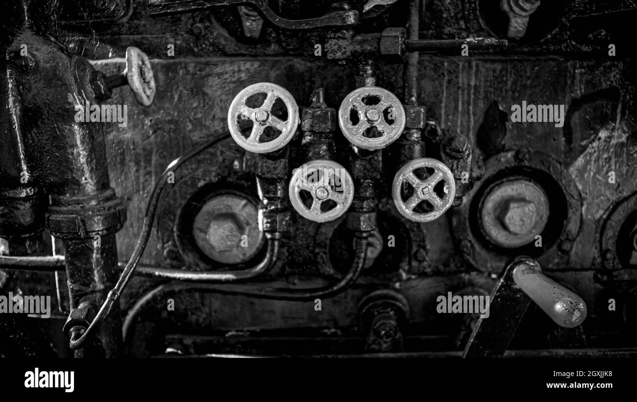 Black and white image of valves and faucets on old steam powered train ...