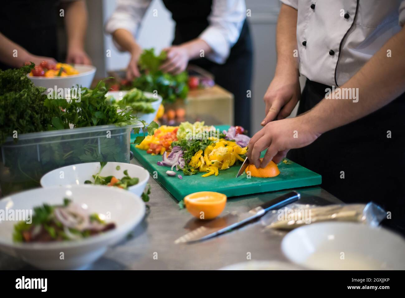 Female chef preparing dish team hi-res stock photography and images - Alamy