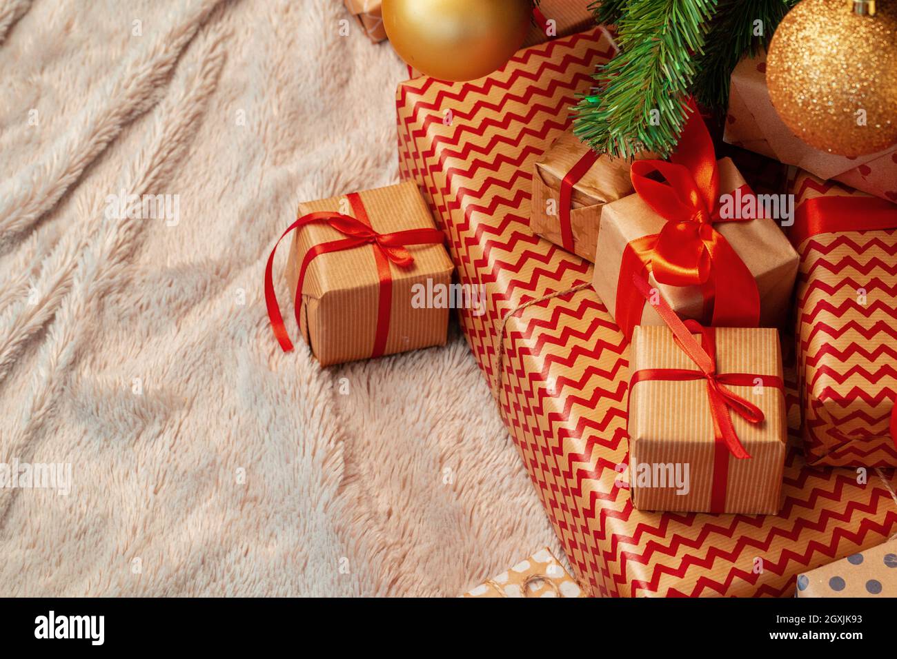 Stack of wrapped presents under Christmas tree Stock Photo - Alamy