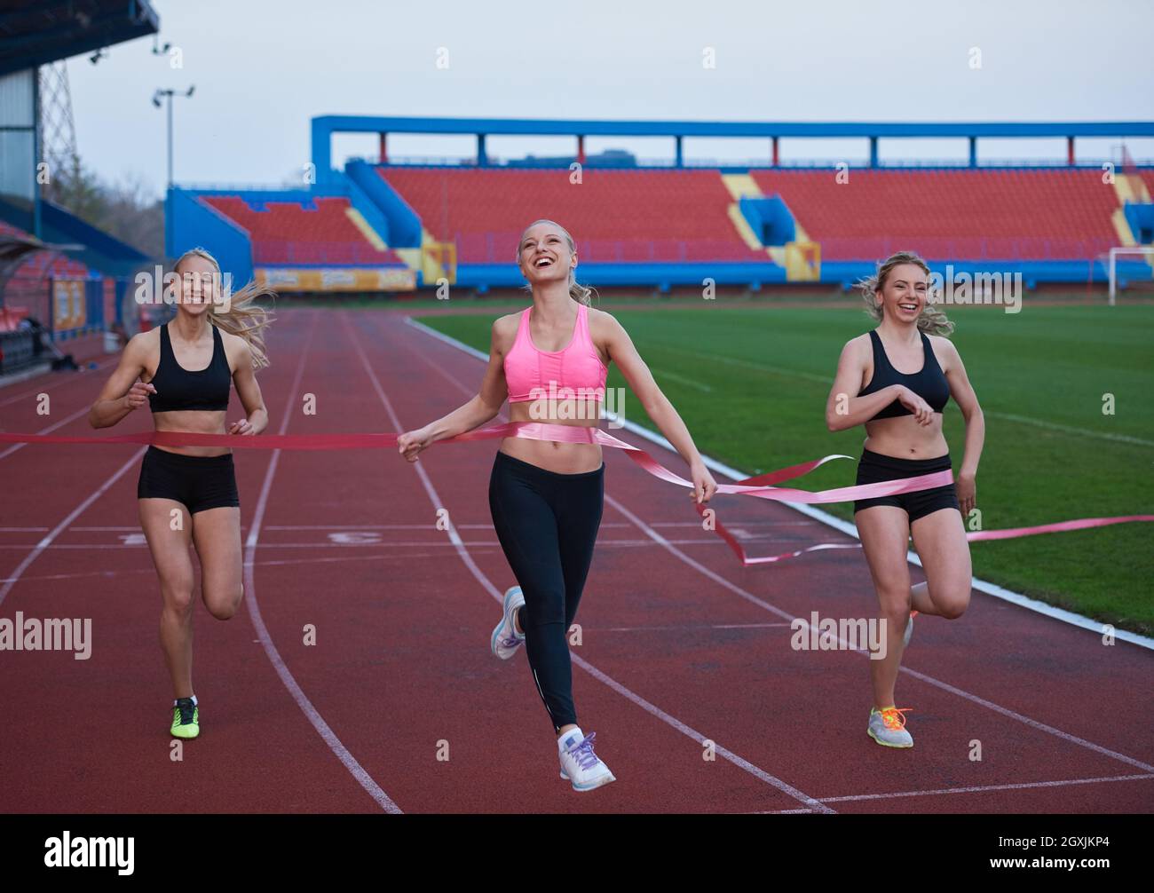 Female Runners Finishing athletic Race Together Stock Photo - Alamy