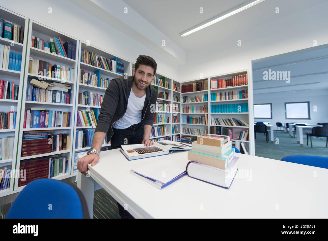Student reading book in school library. Study lessons for exam. Hard ...