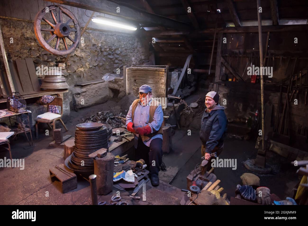 portrait of two generations traditional confident blacksmith workers at ...
