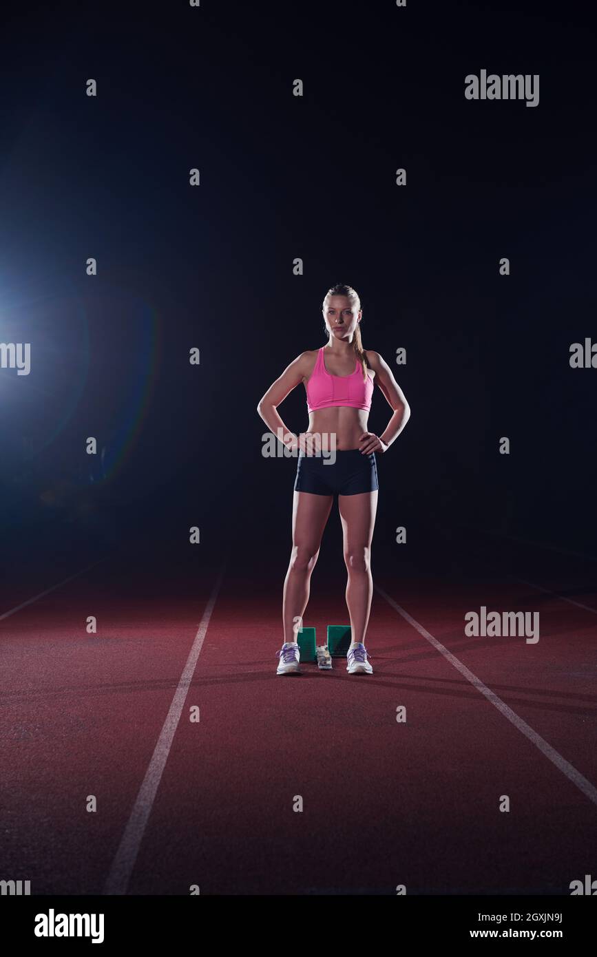 Female sprinter leaving starting blocks hi-res stock photography and ...