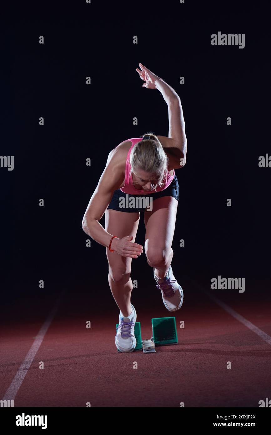 pixelated design of woman sprinter leaving starting blocks on the ...
