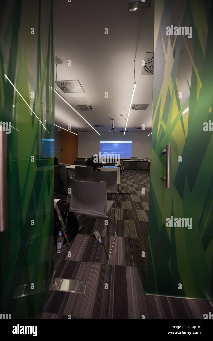 empty it classroom with program code on projector screen and modern ...