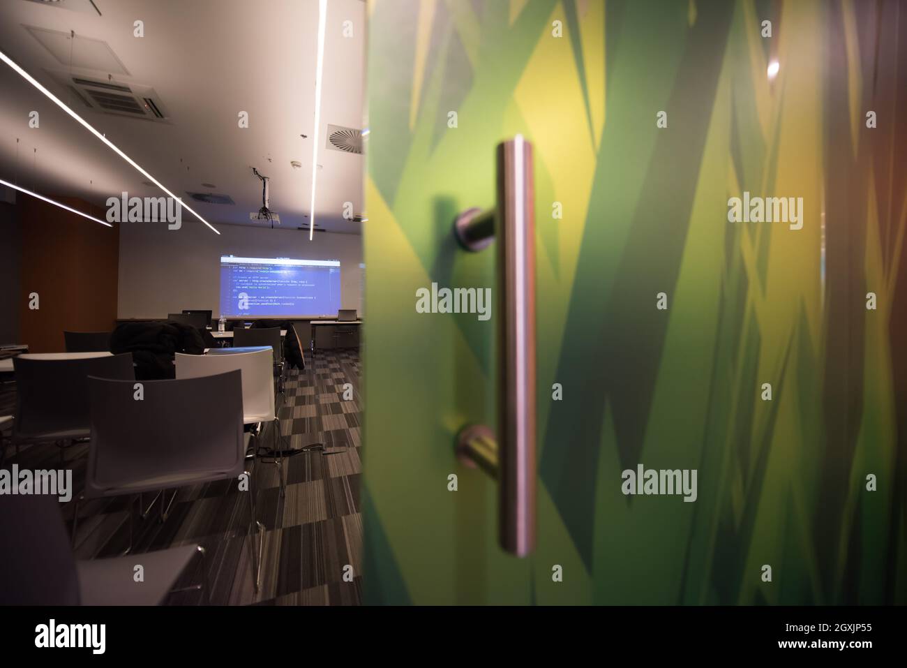 empty it classroom with program code on projector screen and modern ...