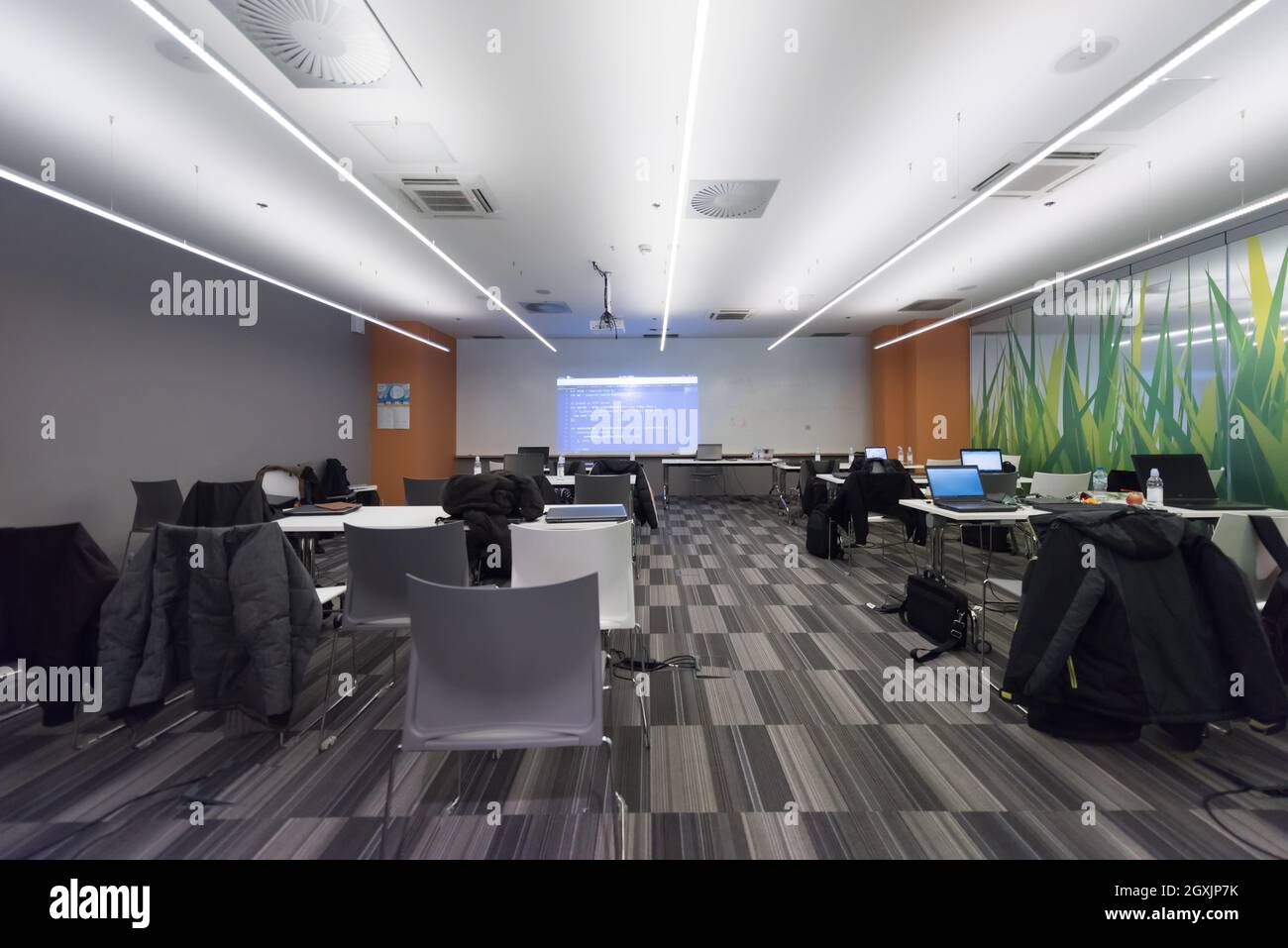 empty it classroom with program code on projector screen and modern ...