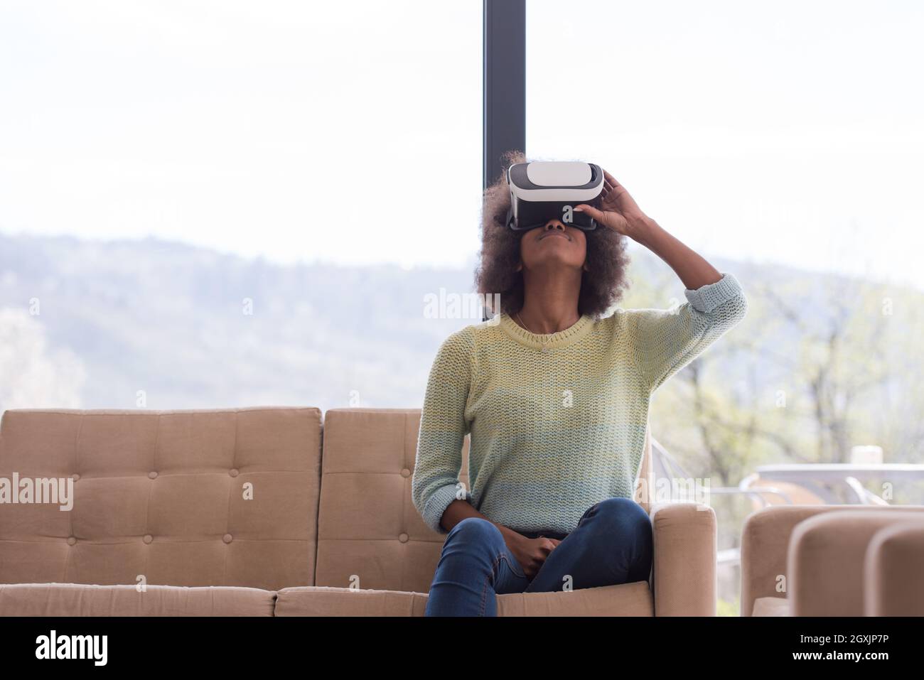 Happy african american girl getting experience using VR headset glasses ...