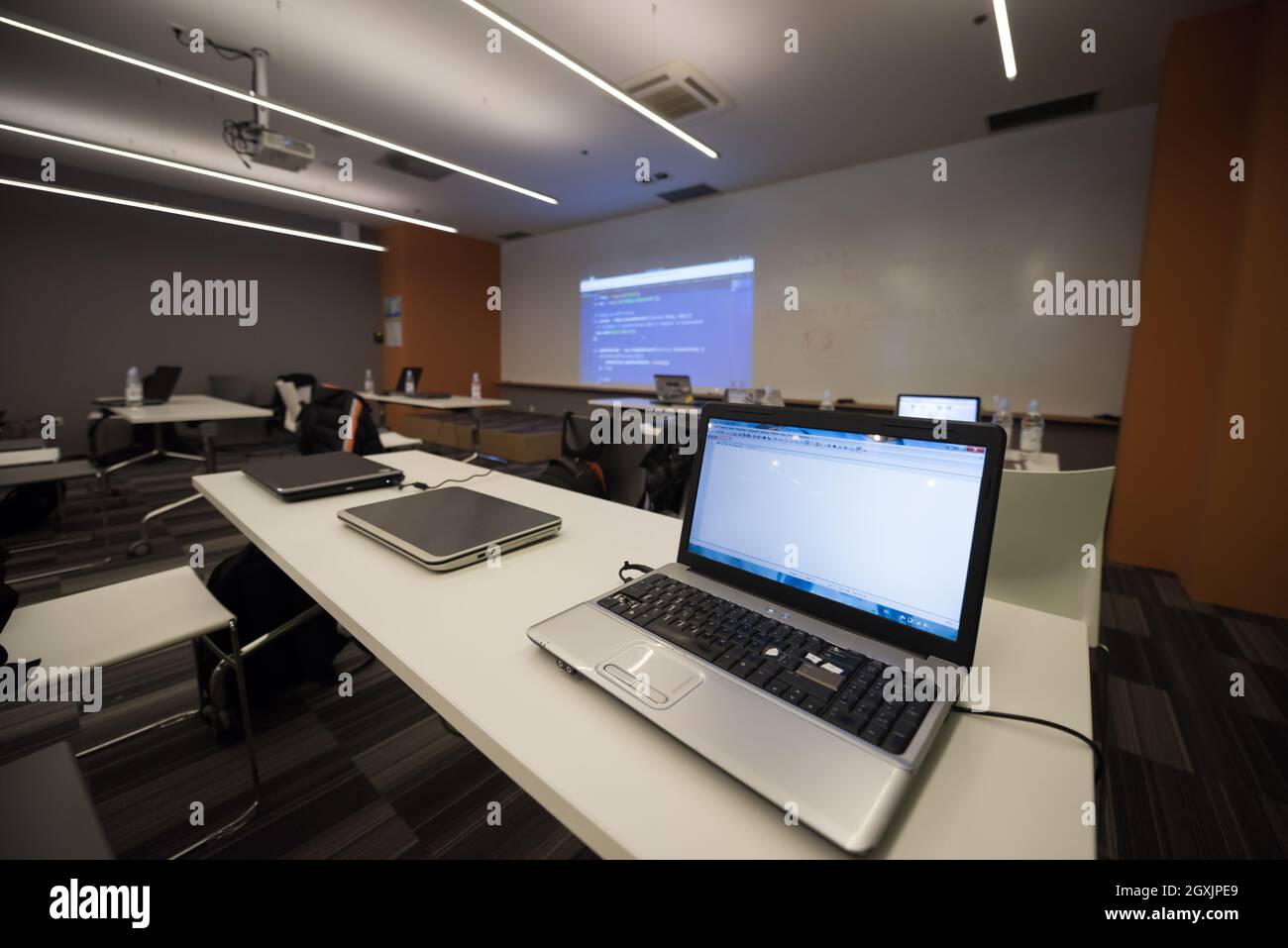 empty it classroom with program code on projector screen and modern ...