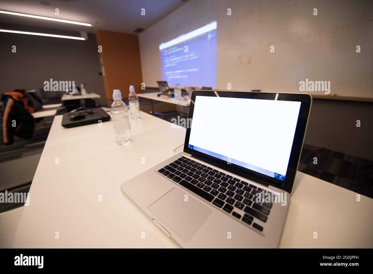 empty it classroom with program code on projector screen and modern ...
