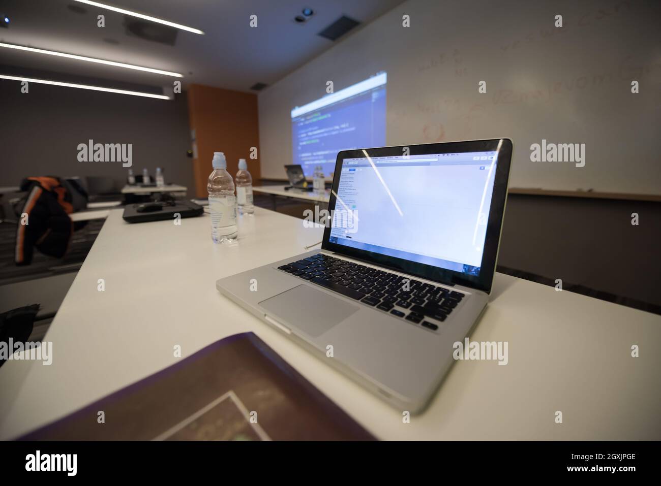 empty it classroom with program code on projector screen and modern ...
