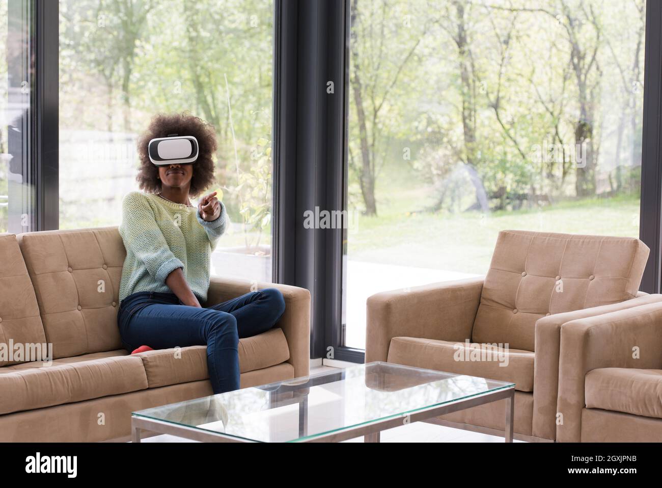 Happy african american girl getting experience using VR headset glasses ...