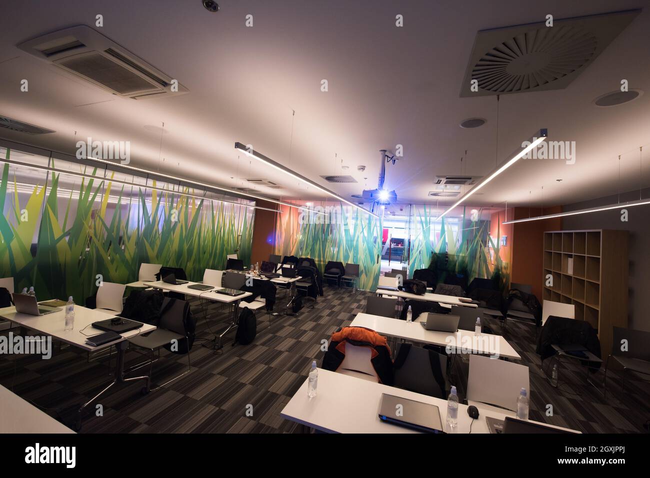 empty it classroom with program code on projector screen and modern ...