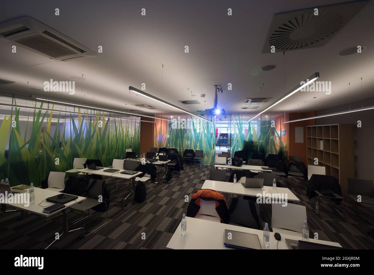 empty it classroom with program code on projector screen and modern ...