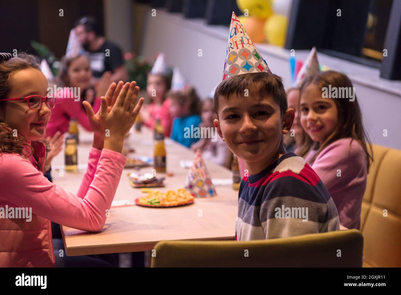 The young boy joyfully celebrating his birthday with a group of his ...