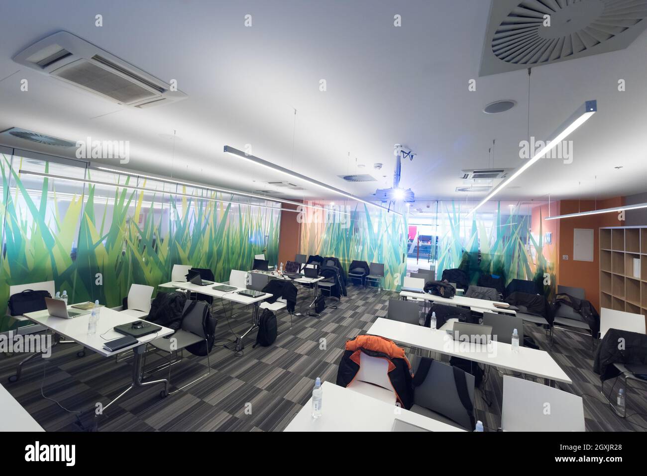 empty it classroom with program code on projector screen and modern ...