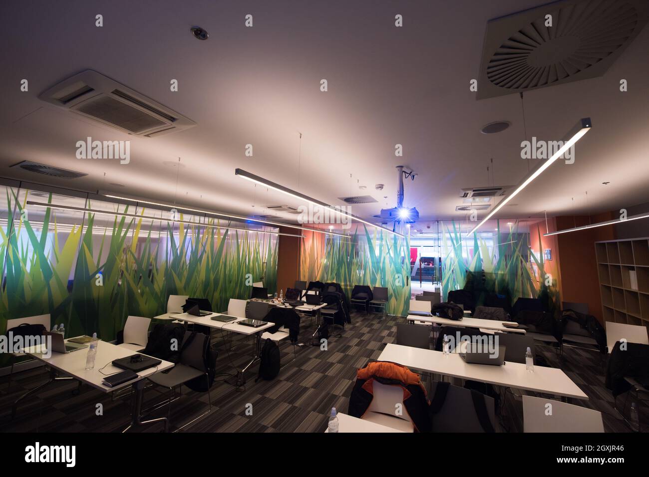 empty it classroom with program code on projector screen and modern ...