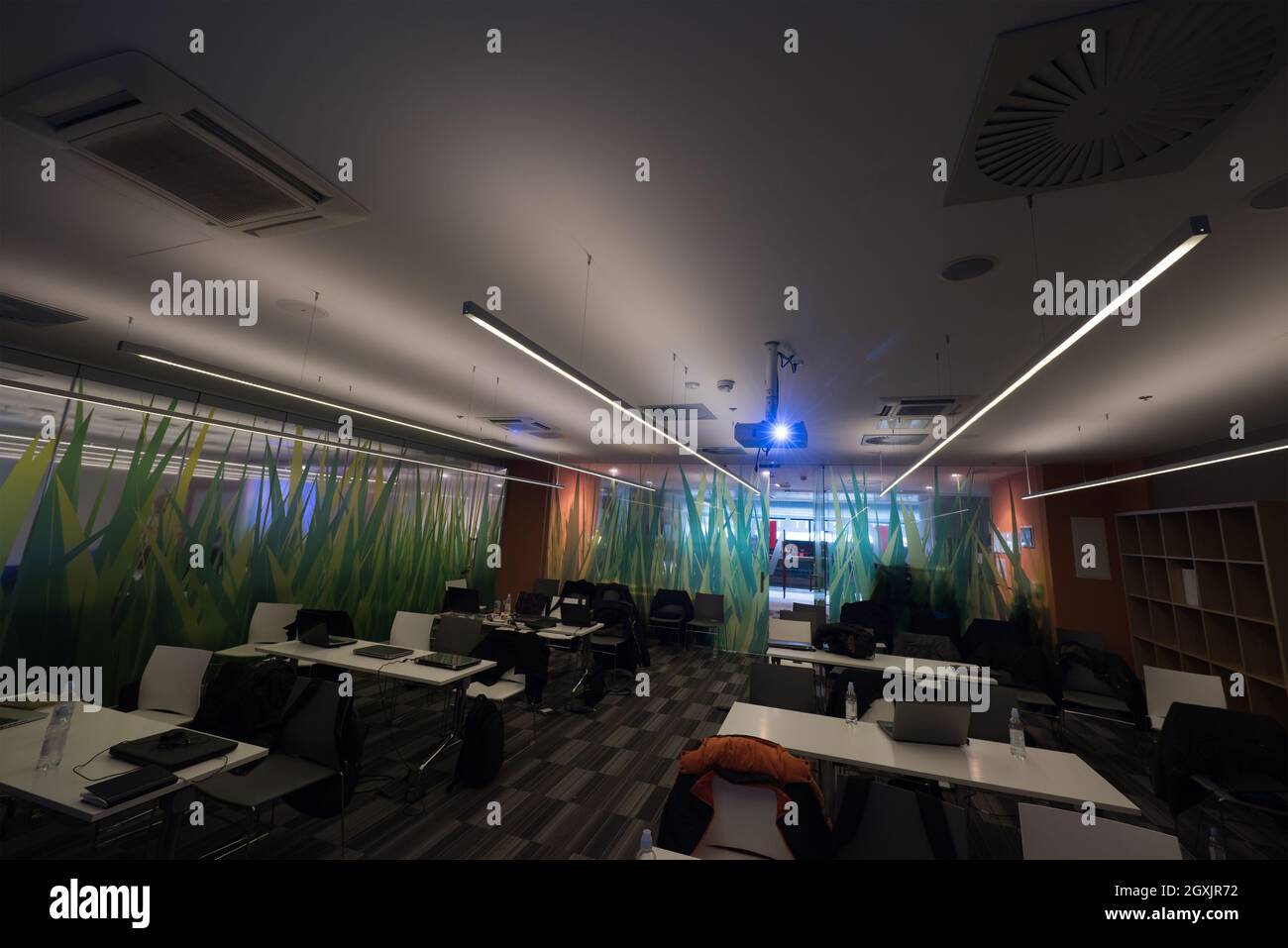 empty it classroom with program code on projector screen and modern ...