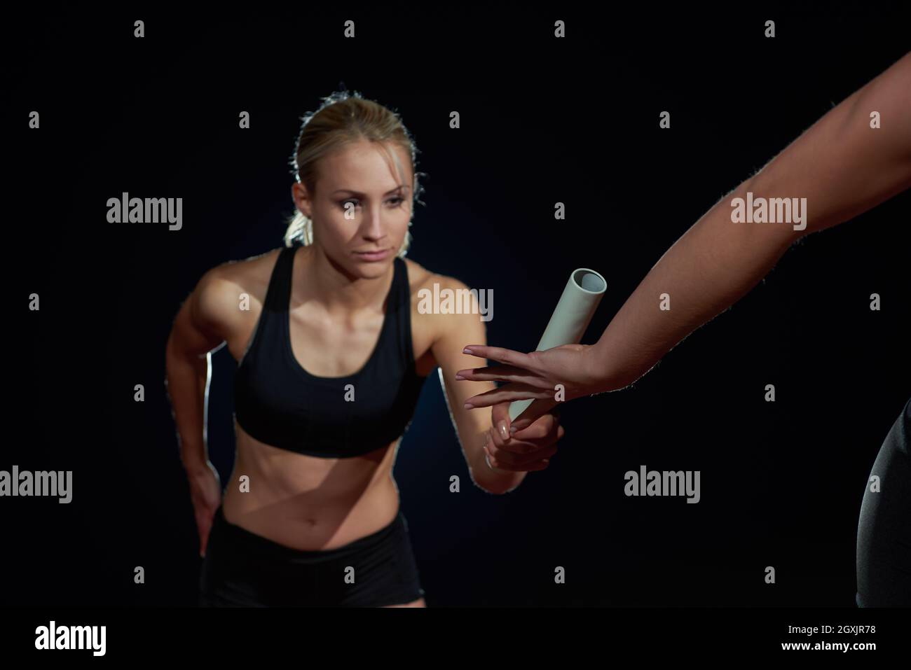 Relay racers passing the baton hi-res stock photography and images - Alamy