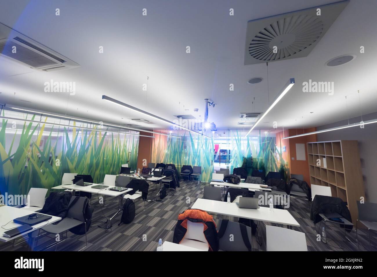 empty it classroom with program code on projector screen and modern ...