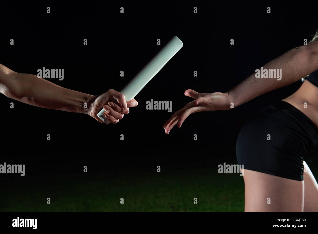 woman athletic runners passing baton in relay race Stock Photo - Alamy