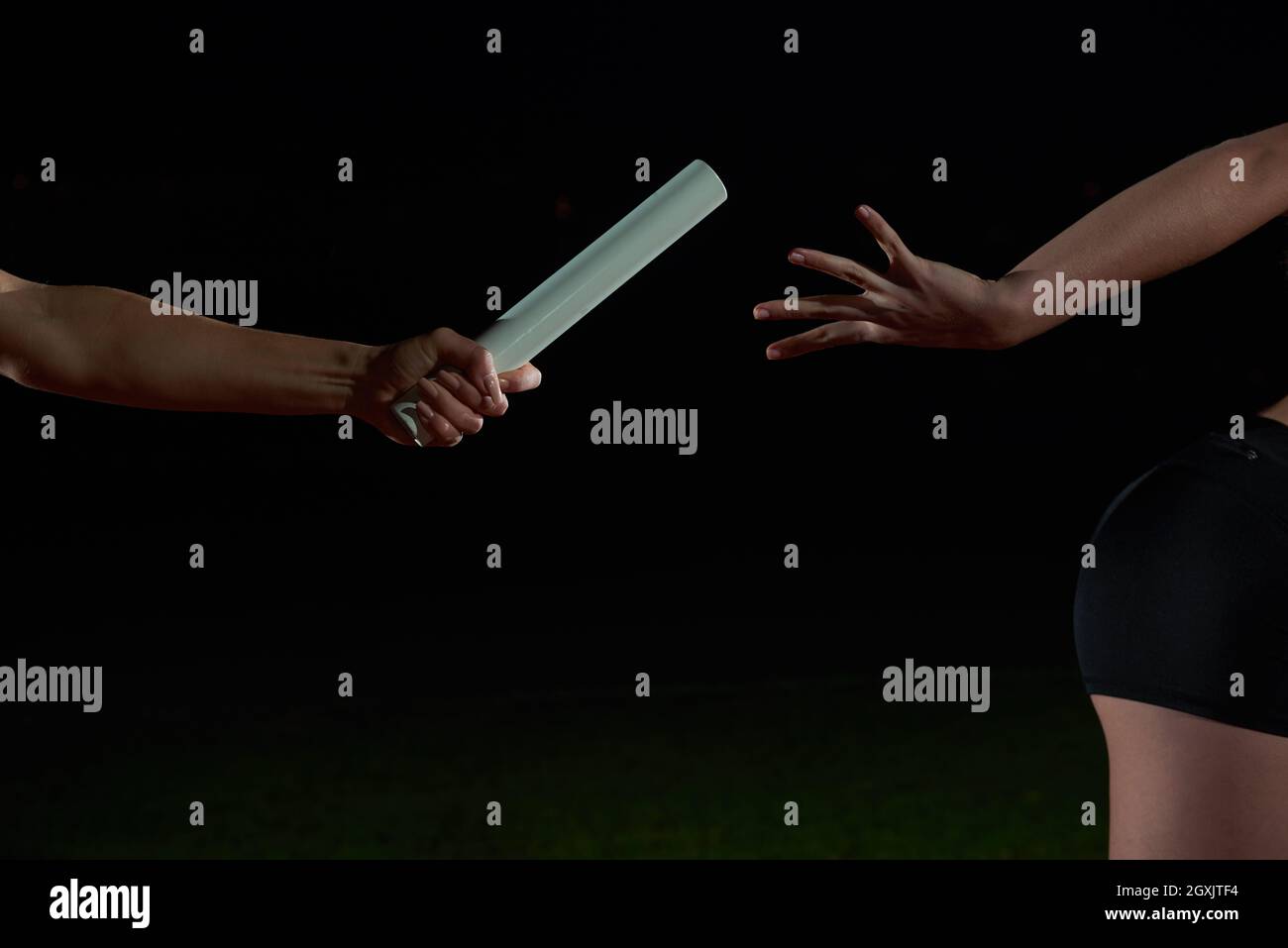woman athletic runners passing baton in relay race Stock Photo - Alamy