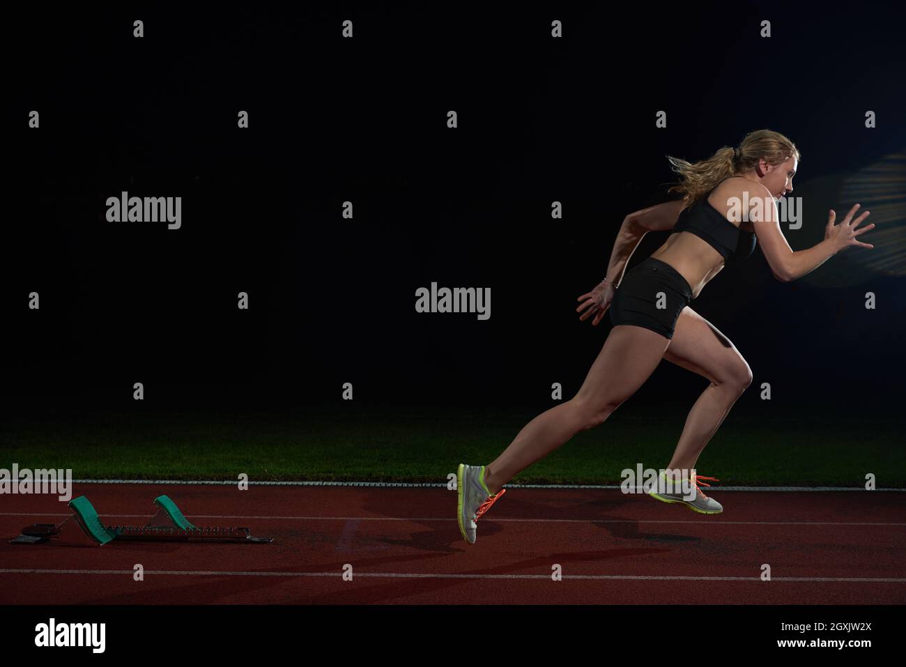 Female sprinter leaving starting blocks hi-res stock photography and ...